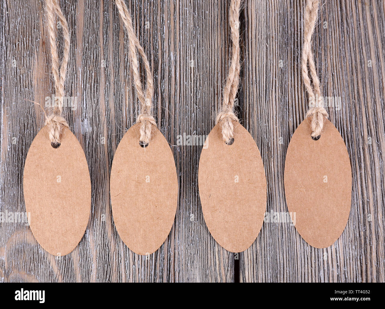 Brown tags on wooden background Stock Photo - Alamy