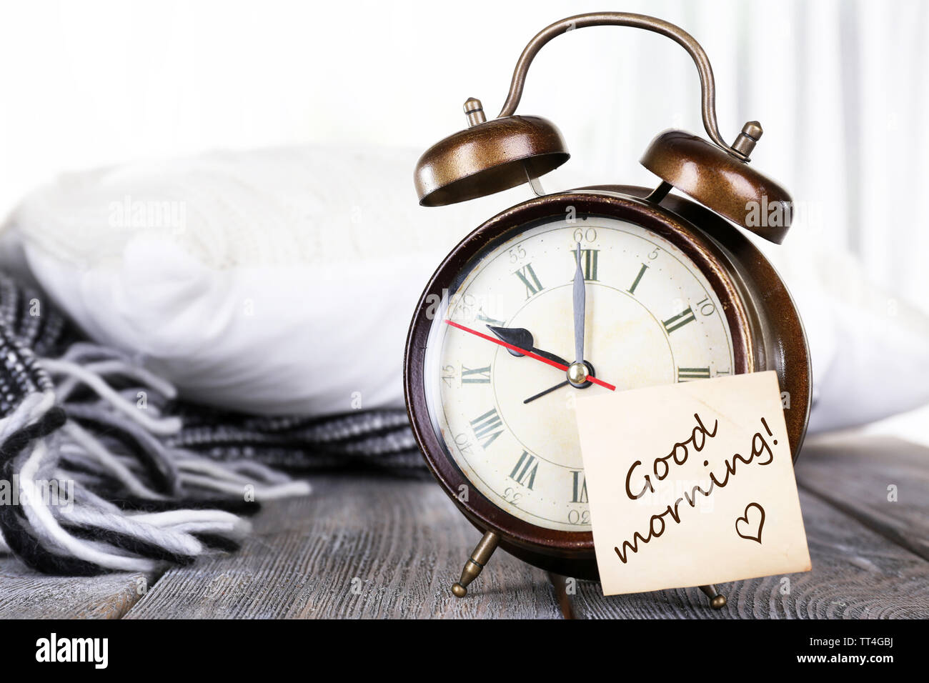 Note GOOD MORNING on alarm clock against bright background Stock Photo ...