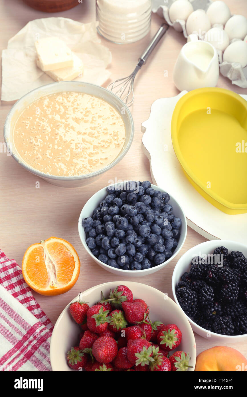 Baking tasty pie and ingredients for it on table in kitchen Stock Photo ...