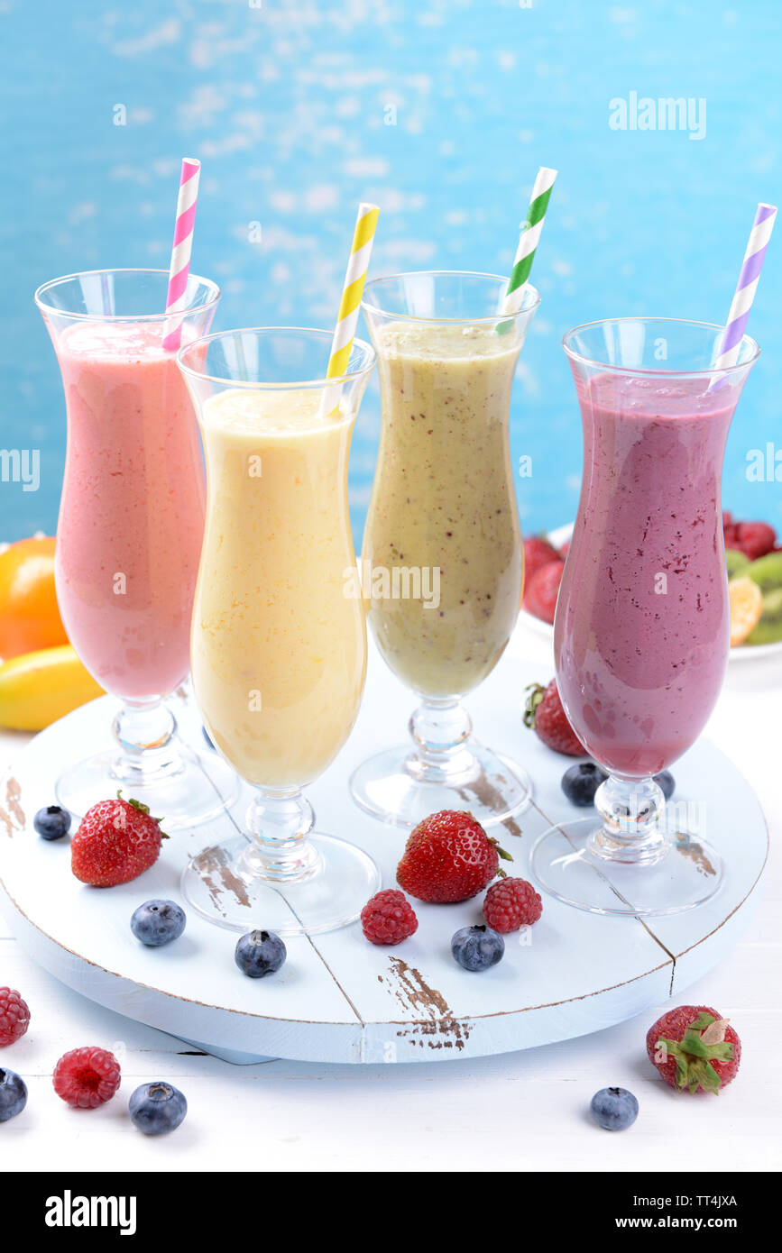 Delicious berry cocktails on table on water background Stock Photo - Alamy