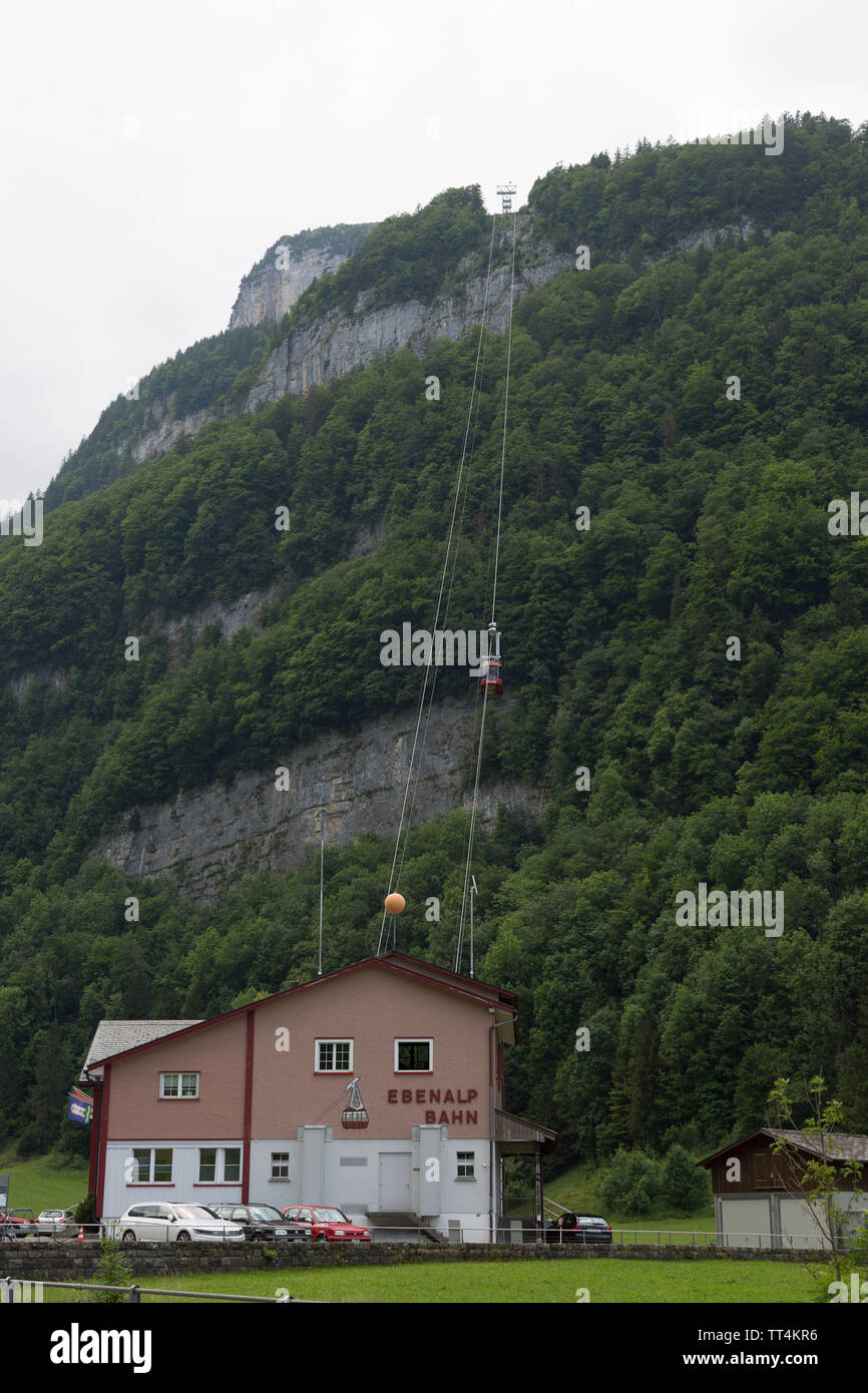 The cable cars traveling the steep incline at Ebenalp, Appenzell ...
