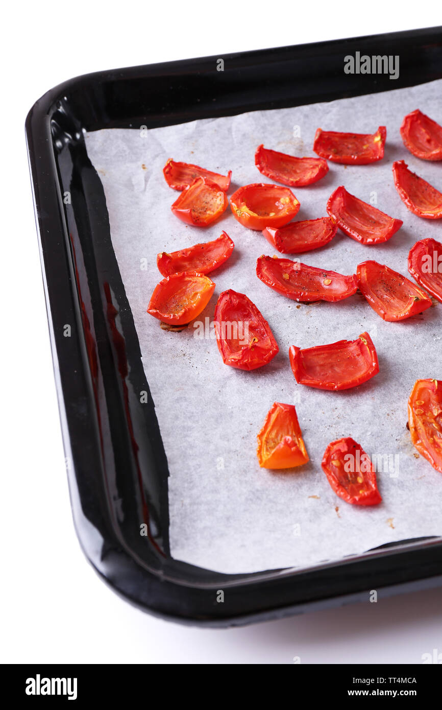 Sun dried tomatoes on drying tray, isolated on white Stock Photo - Alamy