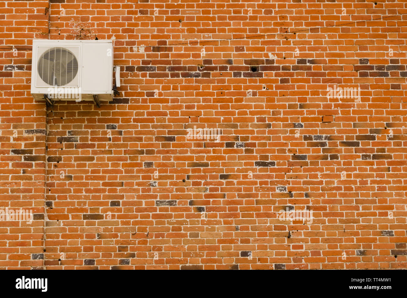 Air conditioning on a background of old red brick wall Stock Photo - Alamy