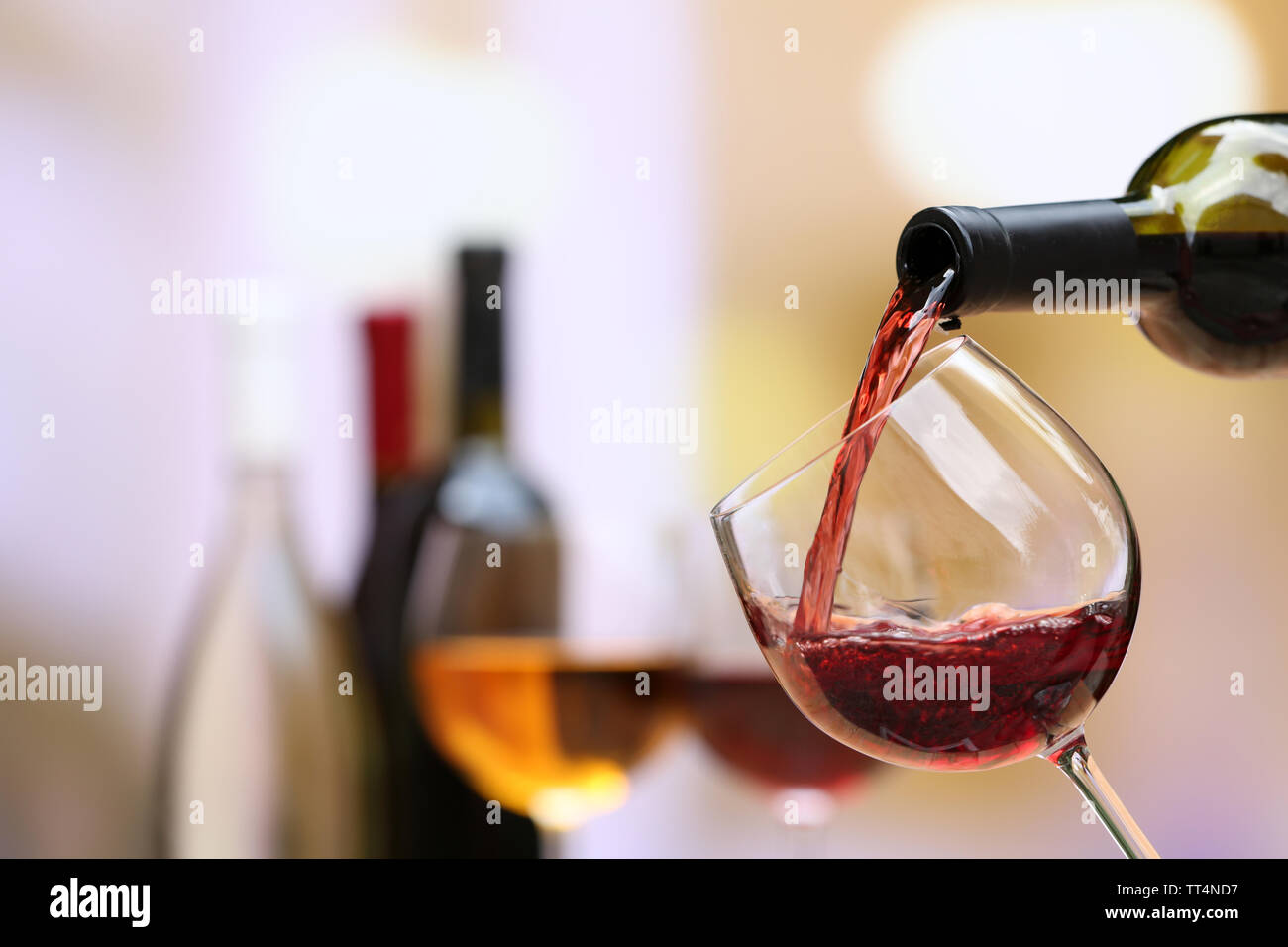 Red wine pouring into wine glass, close-up Stock Photo - Alamy