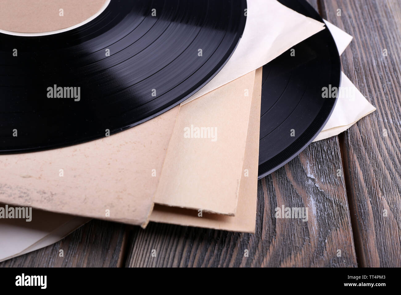 Vinyl records records and paper covers on wooden background Stock Photo ...