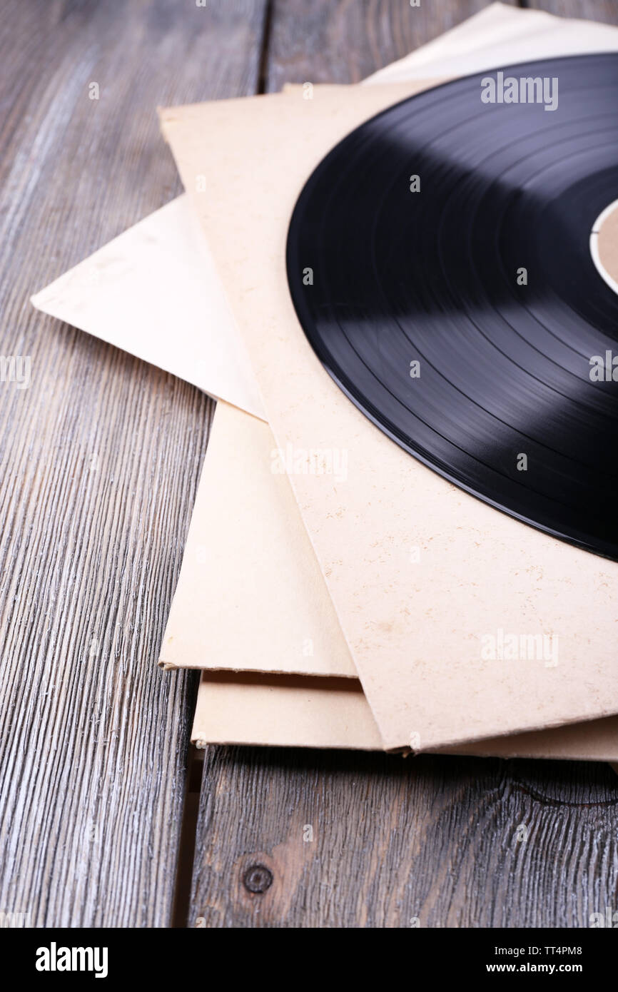 Vinyl records records and paper covers on wooden background Stock Photo ...