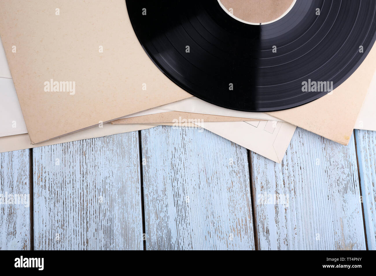 Vinyl records records and paper covers on wooden background Stock Photo ...