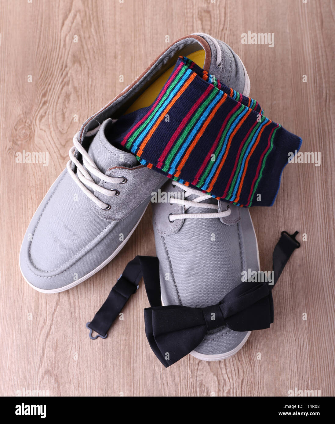 Top-siders, bow-tie and socks on wooden background Stock Photo - Alamy
