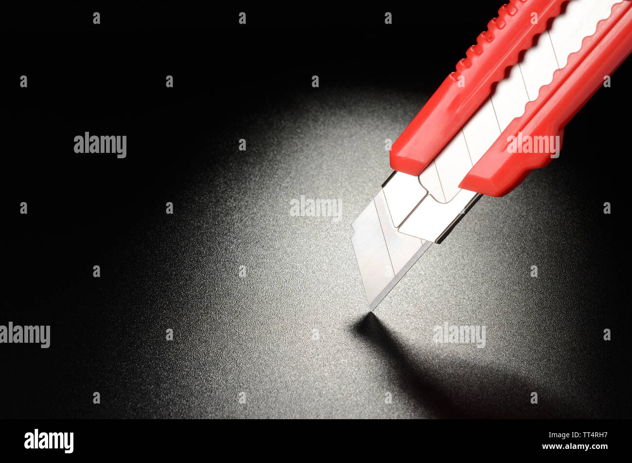 Utility knife, office knife on black grained surface Stock Photo - Alamy