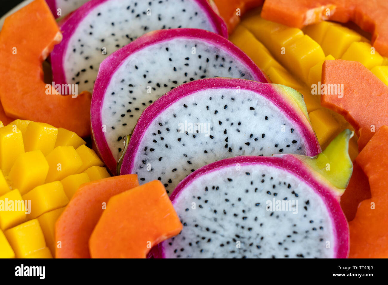 Tropical fruits assortment on a plate, close up. Many colorful ripe ...