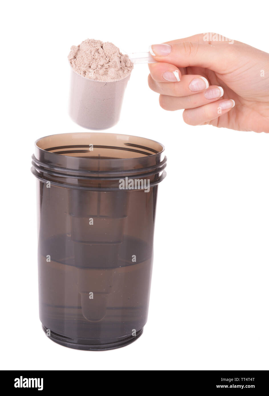 Female hand holding scoop with whey protein powder and plastic shaker ...