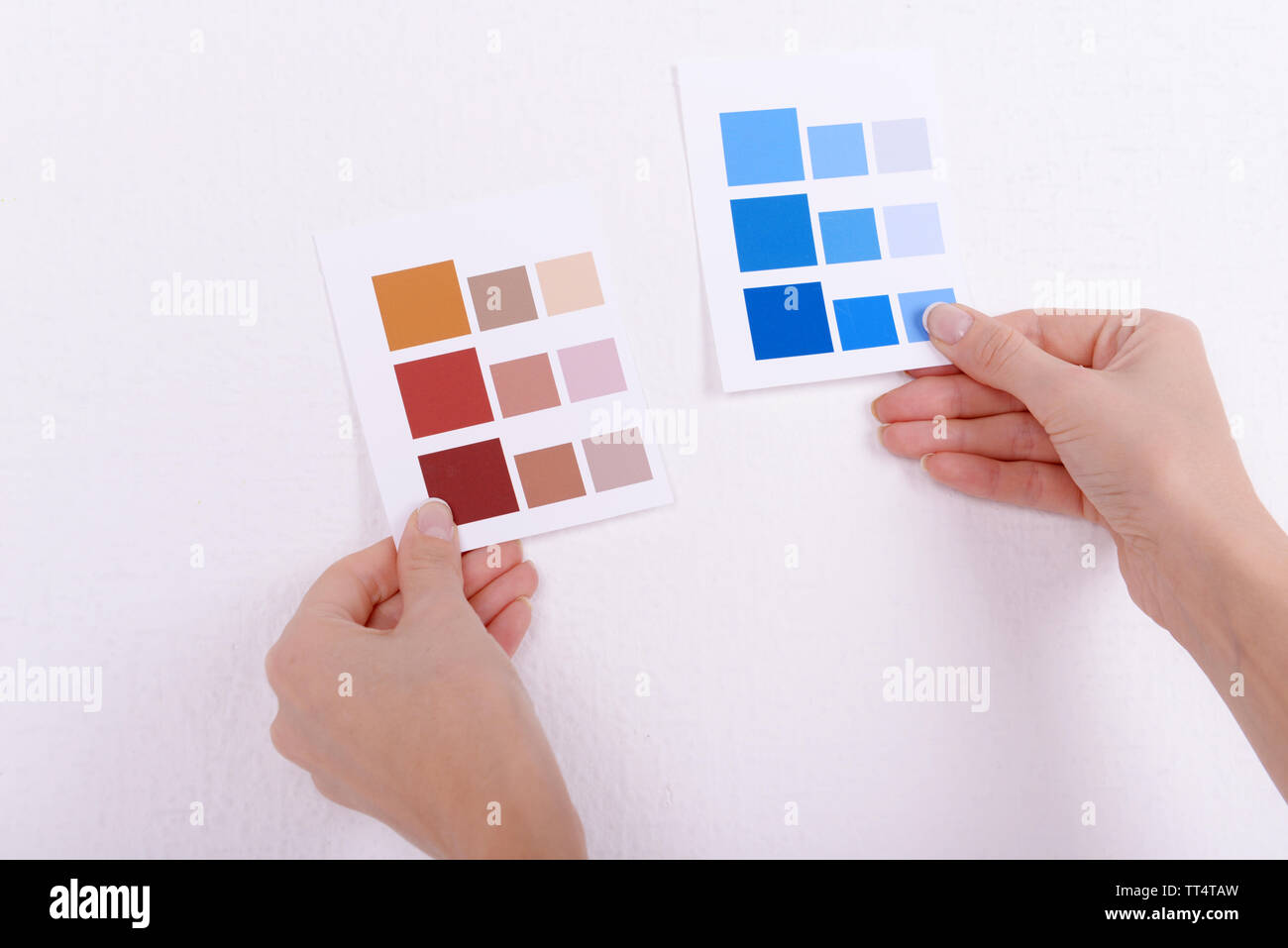 Woman choosing color for wall from swatches in room Stock Photo - Alamy