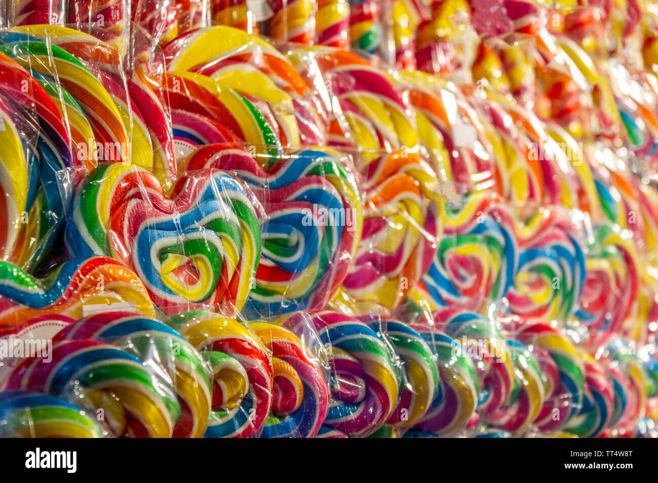 Colorful lollipop candies in nylon packaging Stock Photo - Alamy