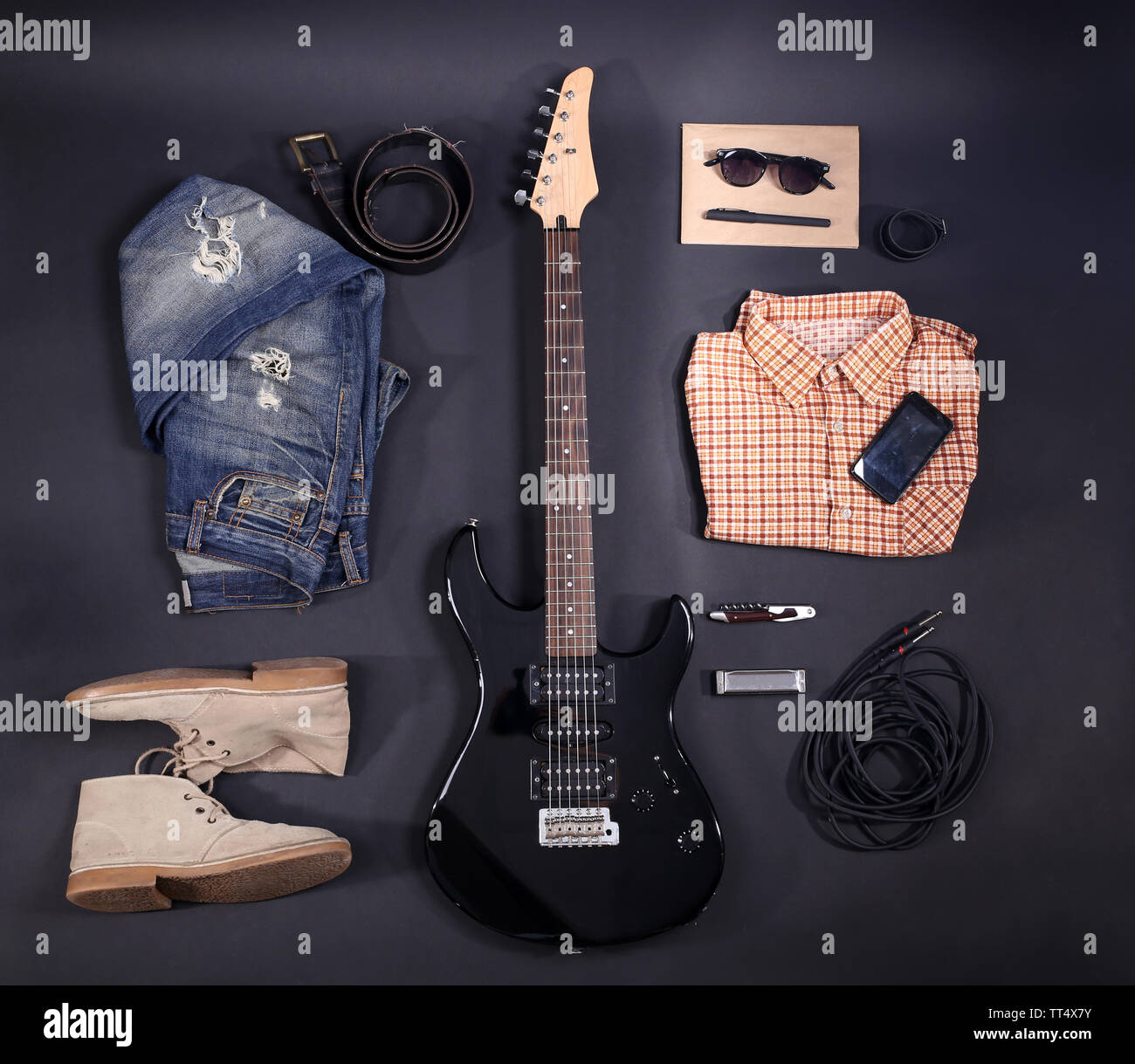 Music equipment, clothes and footwear on black background Stock Photo ...