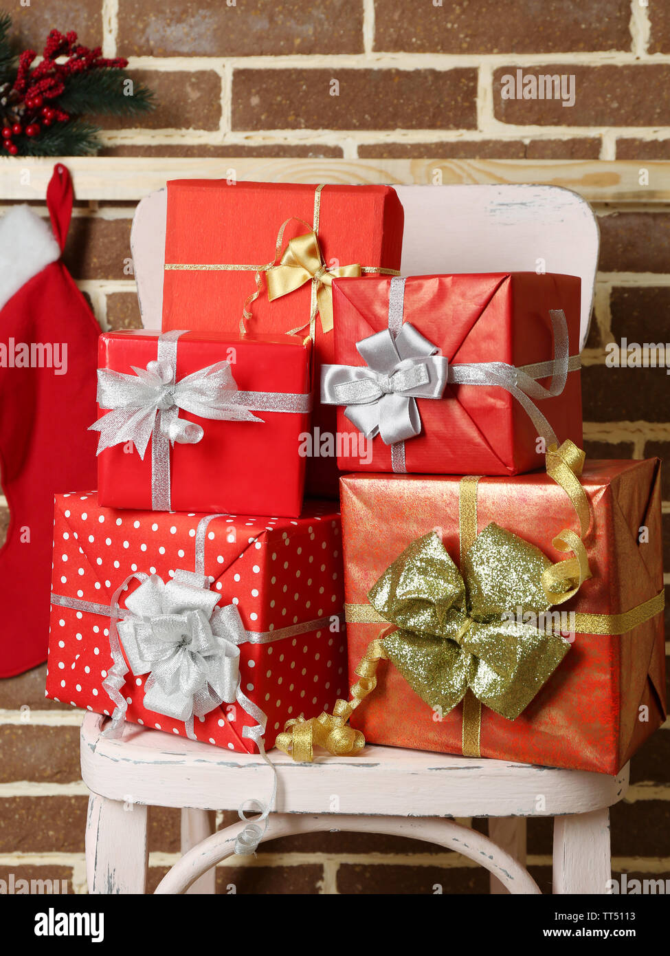 Christmas presents on chair on brown brick wall background Stock Photo ...
