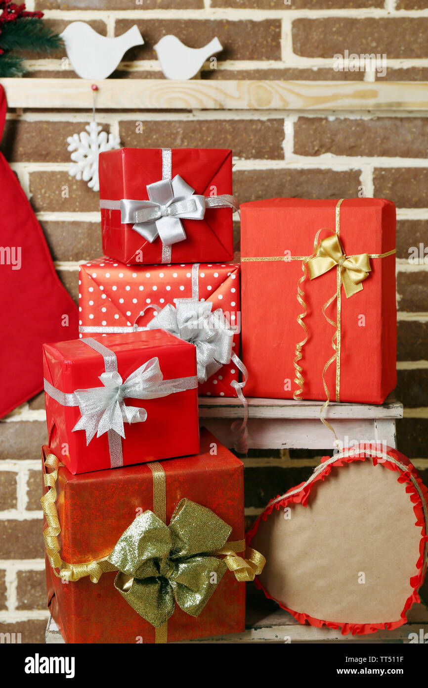 Christmas presents on stand ladder on brown brick wall background Stock ...