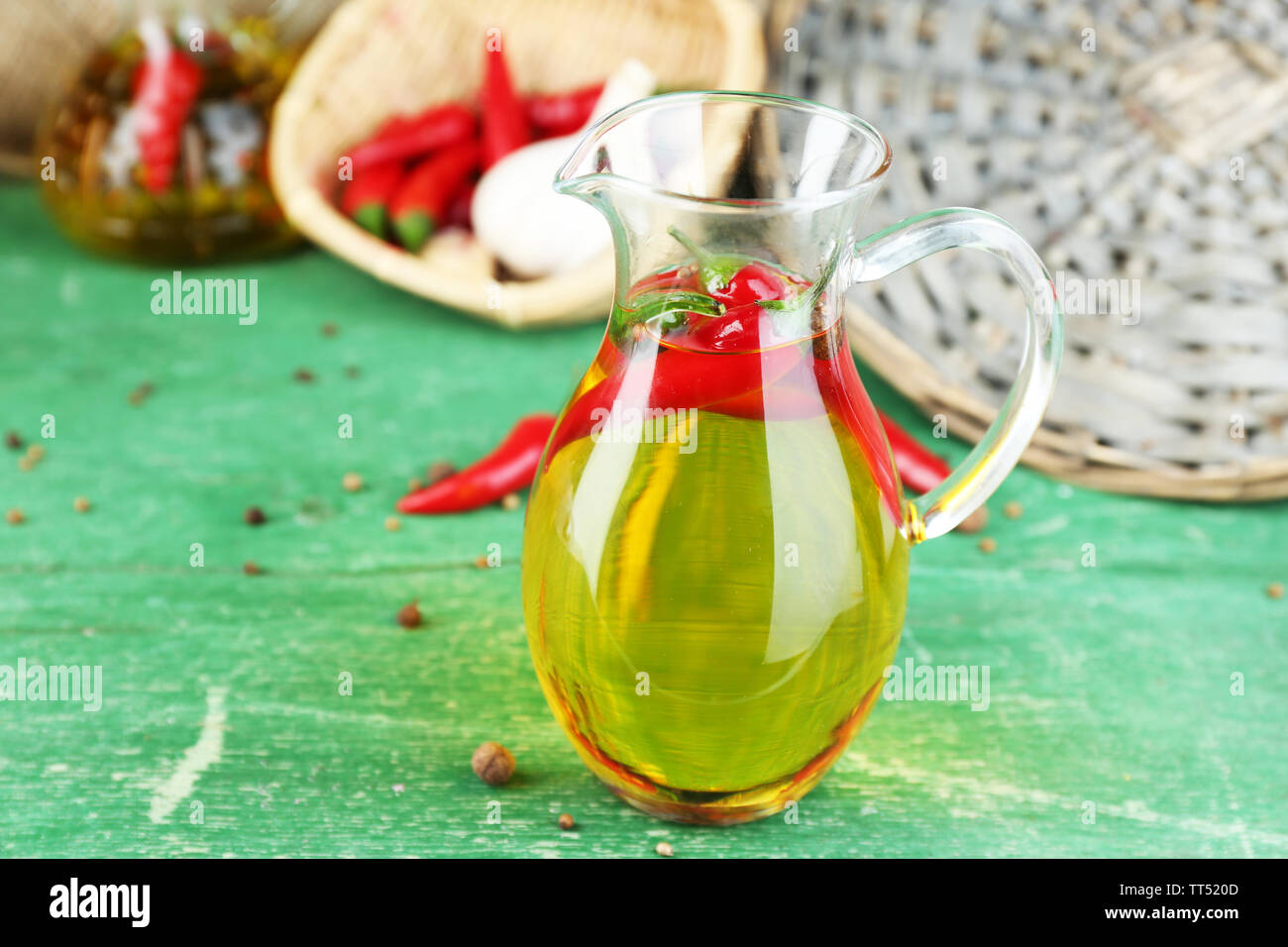 Homemade natural infused olive oil with red chili peppers on color ...