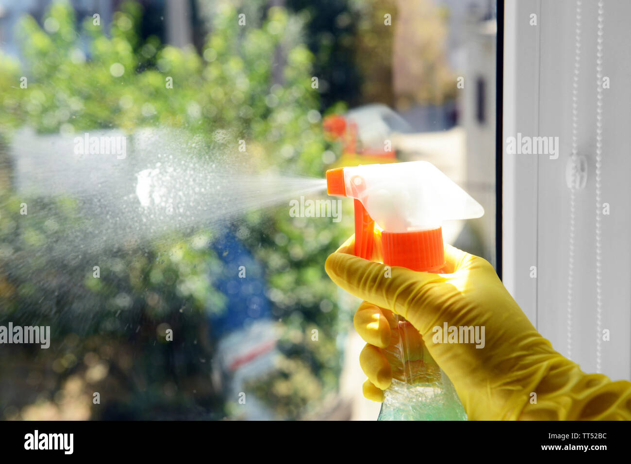 Cleaning window with special cleaner Stock Photo - Alamy