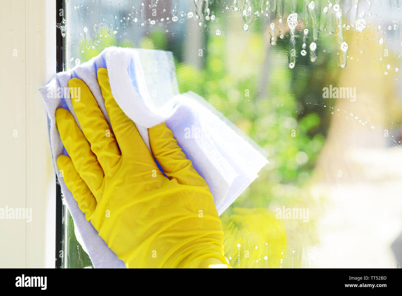 Cleaning windows with special rag Stock Photo - Alamy