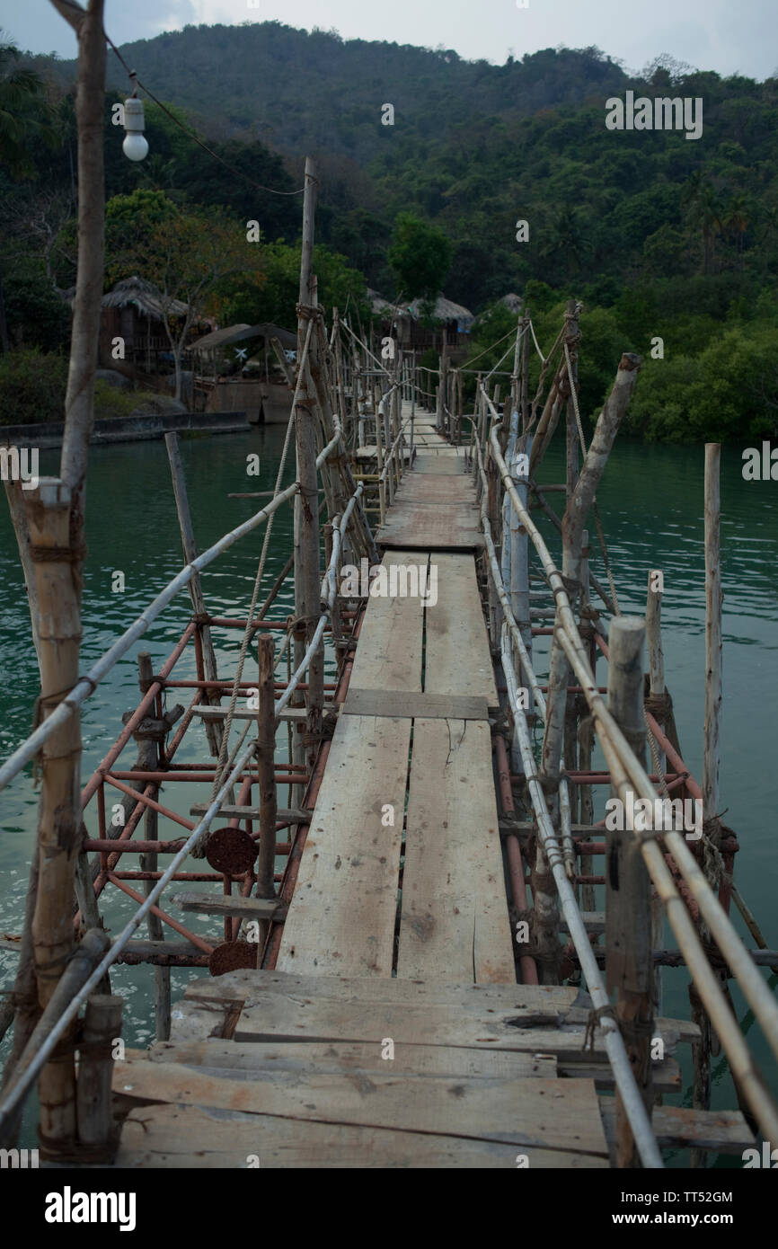 A small wooden walkway joins a village to the mainland in Goa, India ...