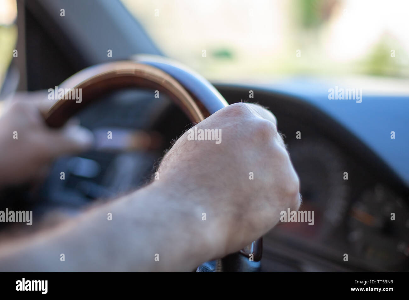 Men's hands on the wheel of the car, transportation Stock Photo - Alamy