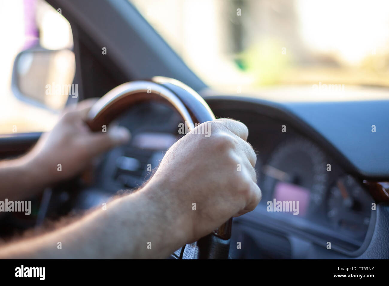 Men's hands on the wheel of the car, transportation Stock Photo - Alamy