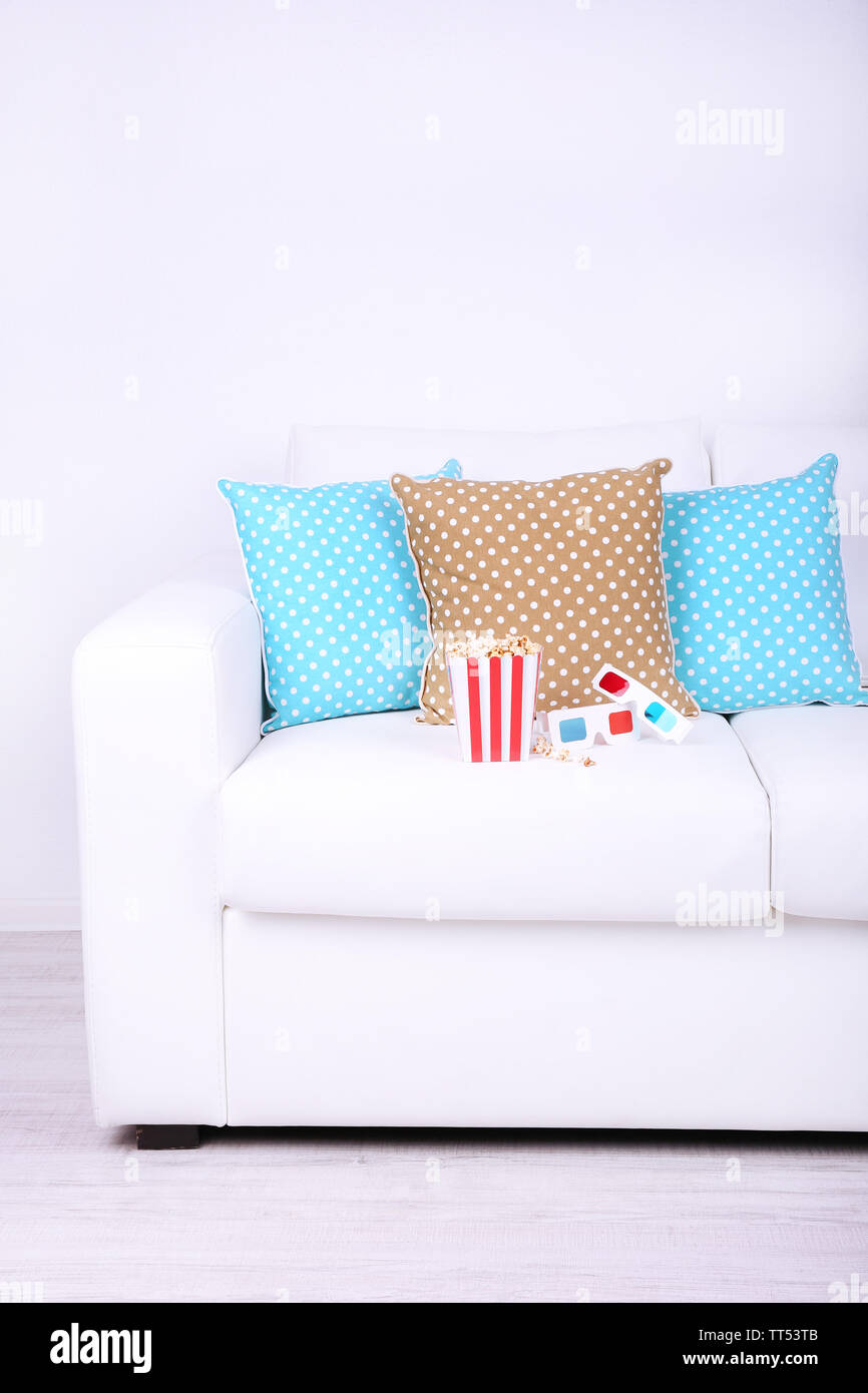 Popcorn and 3D glasses on sofa in room Stock Photo - Alamy