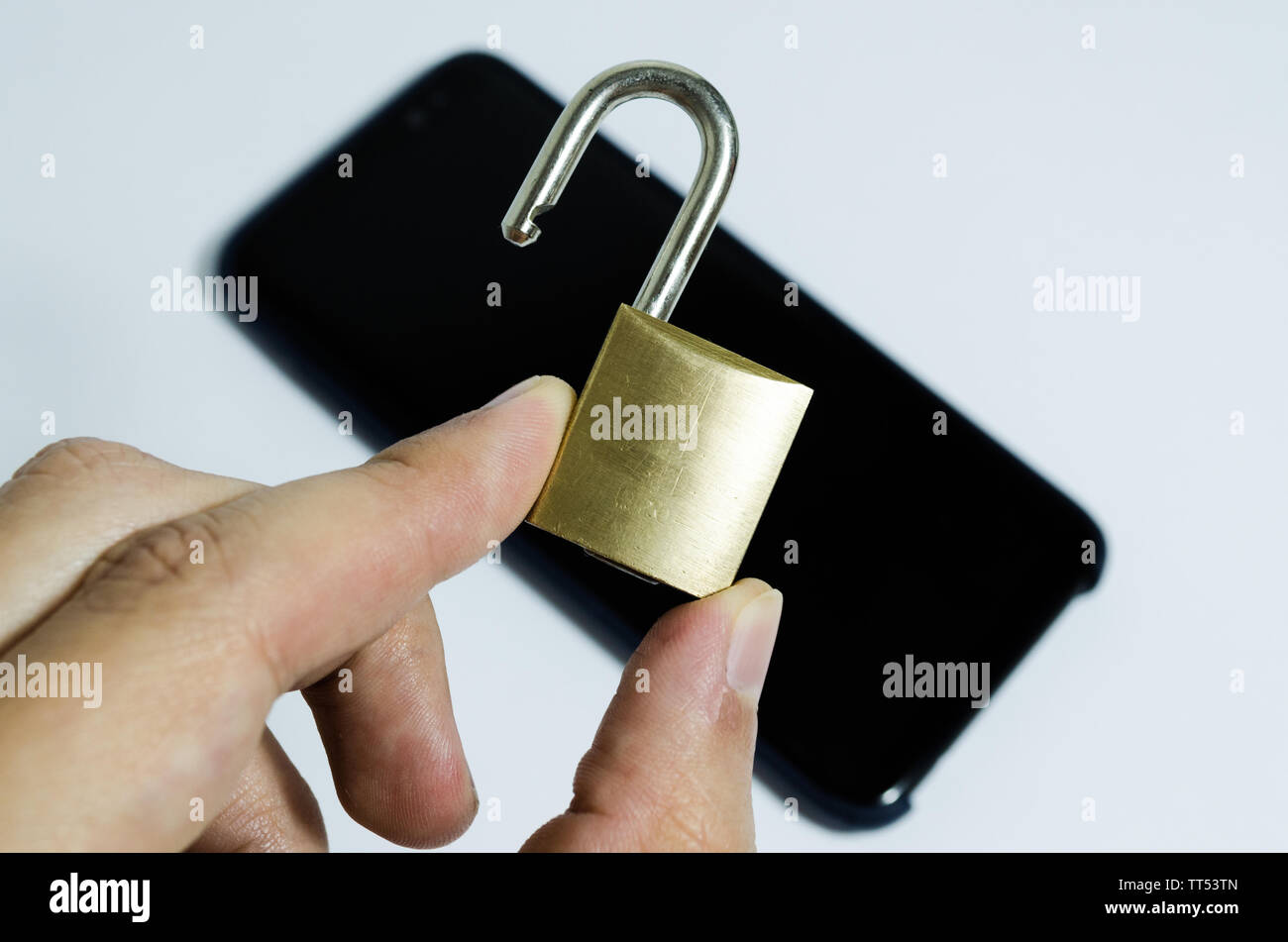 Conceptual photo of security on mobile phones. Hand holding a open ...