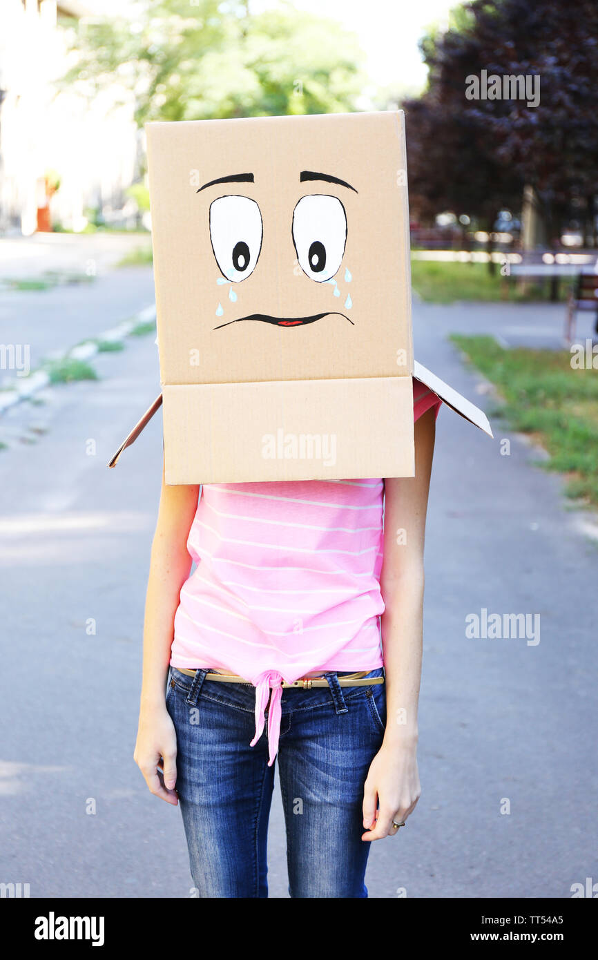 Woman with cardboard box on her head with sad face, outdoors Stock ...