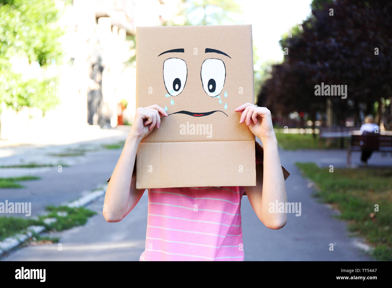 Woman with cardboard box on her head with sad face, outdoors Stock ...