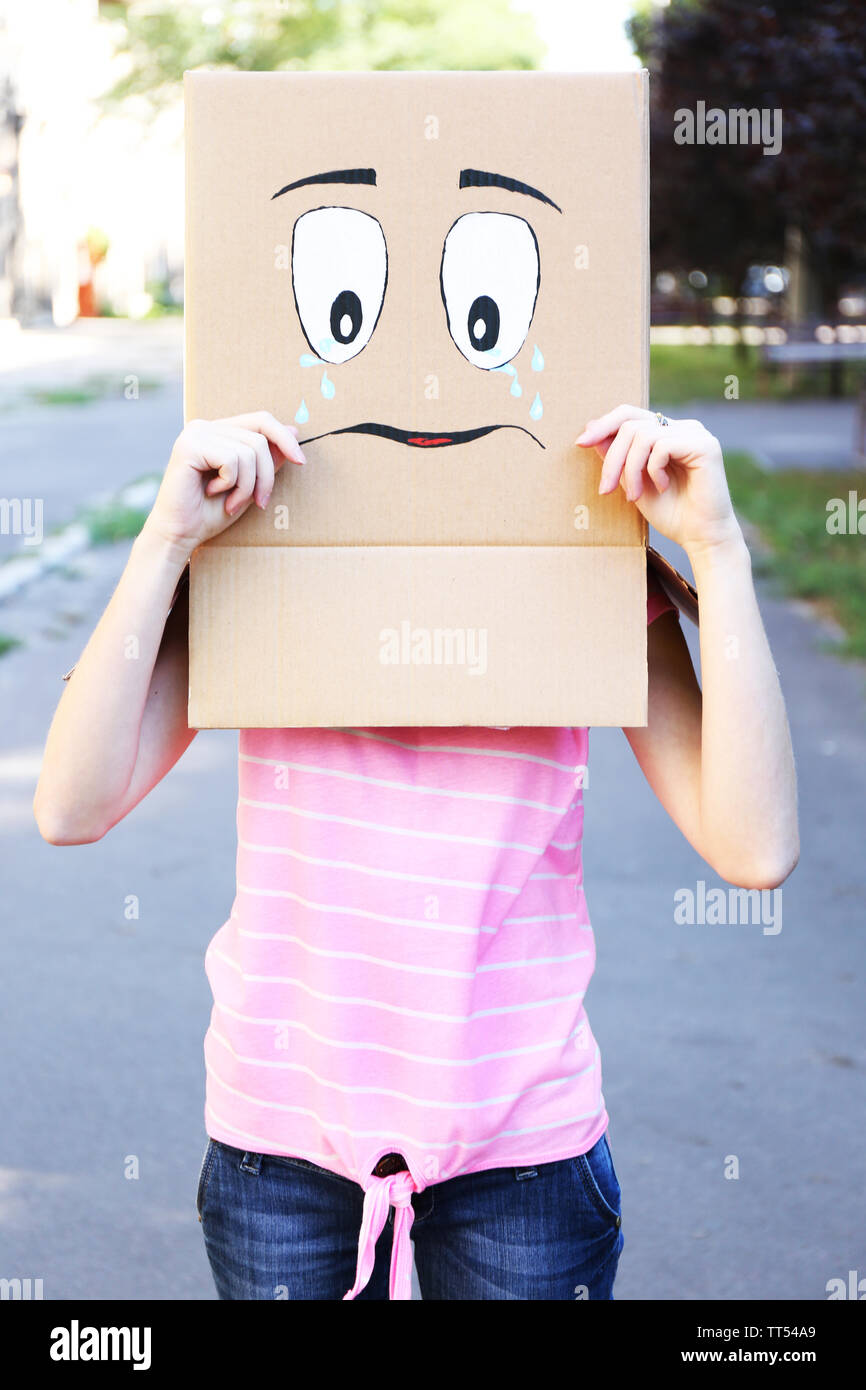 Woman with cardboard box on her head with sad face, outdoors Stock ...