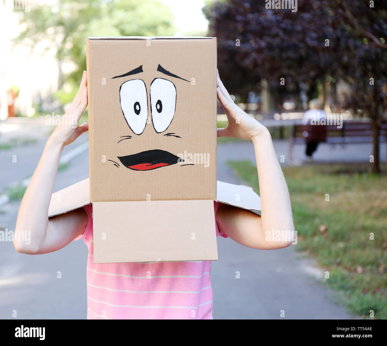 Woman with cardboard box on her head with sad face, outdoors Stock ...