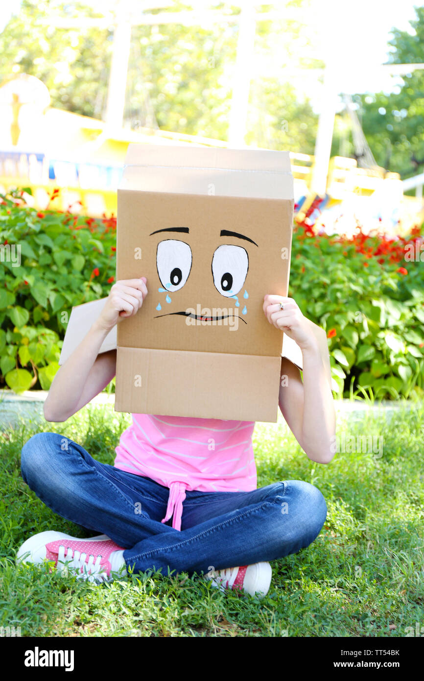 Woman with cardboard box on her head with sad face, outdoors Stock ...