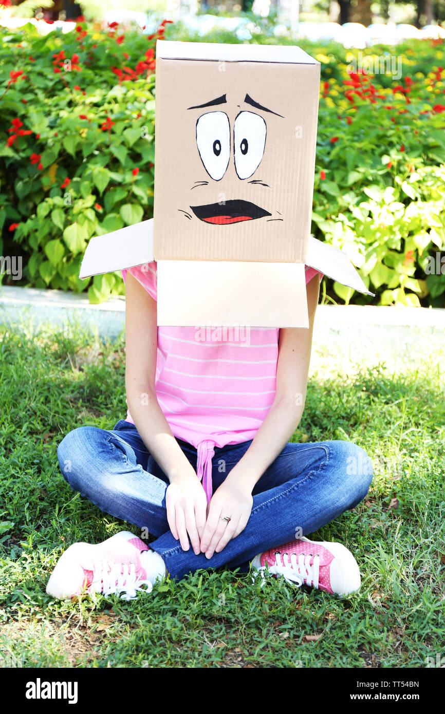 Woman with cardboard box on her head with sad face, outdoors Stock ...