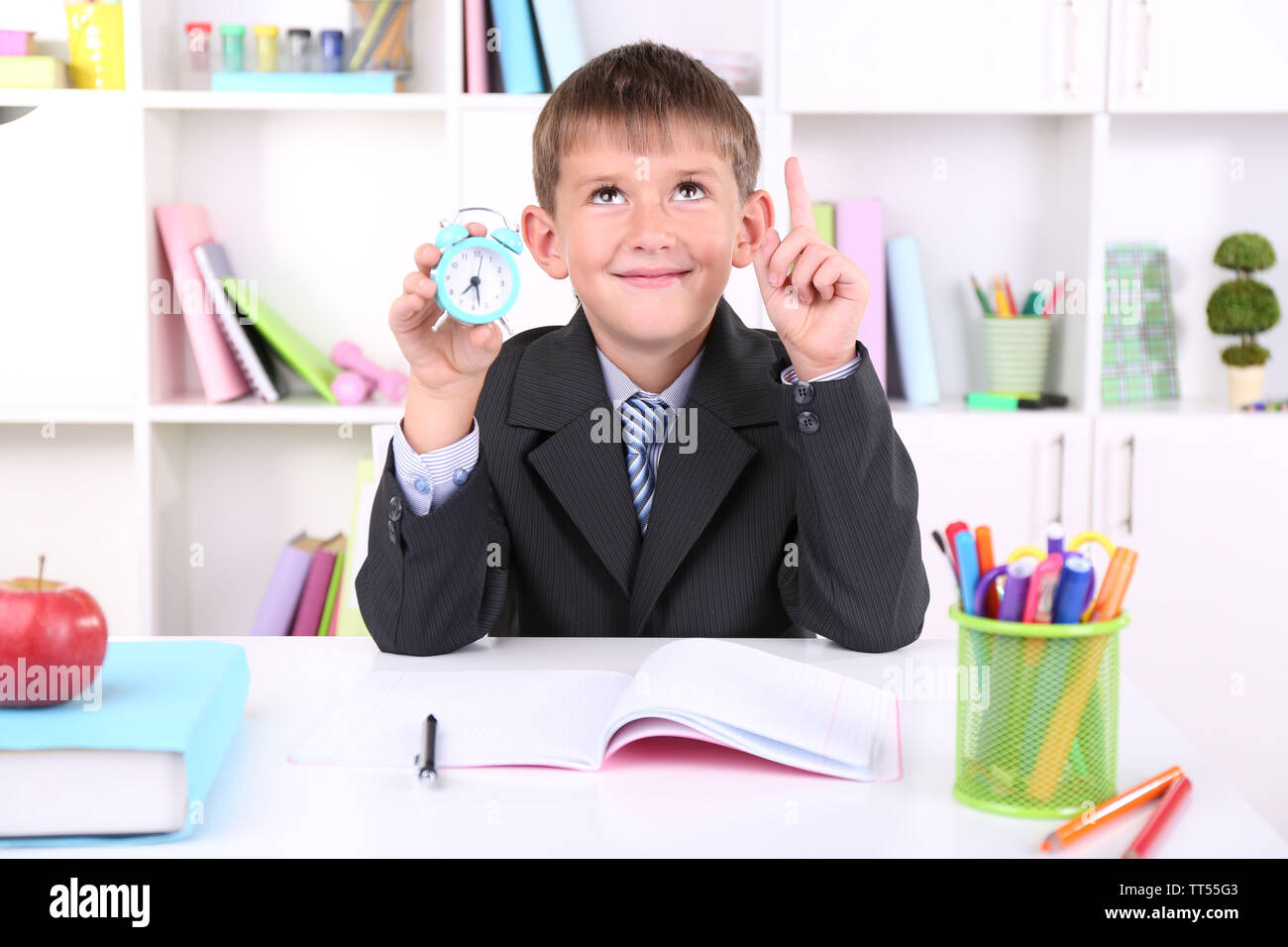 Schoolboy sitting at table in classroom Stock Photo - Alamy