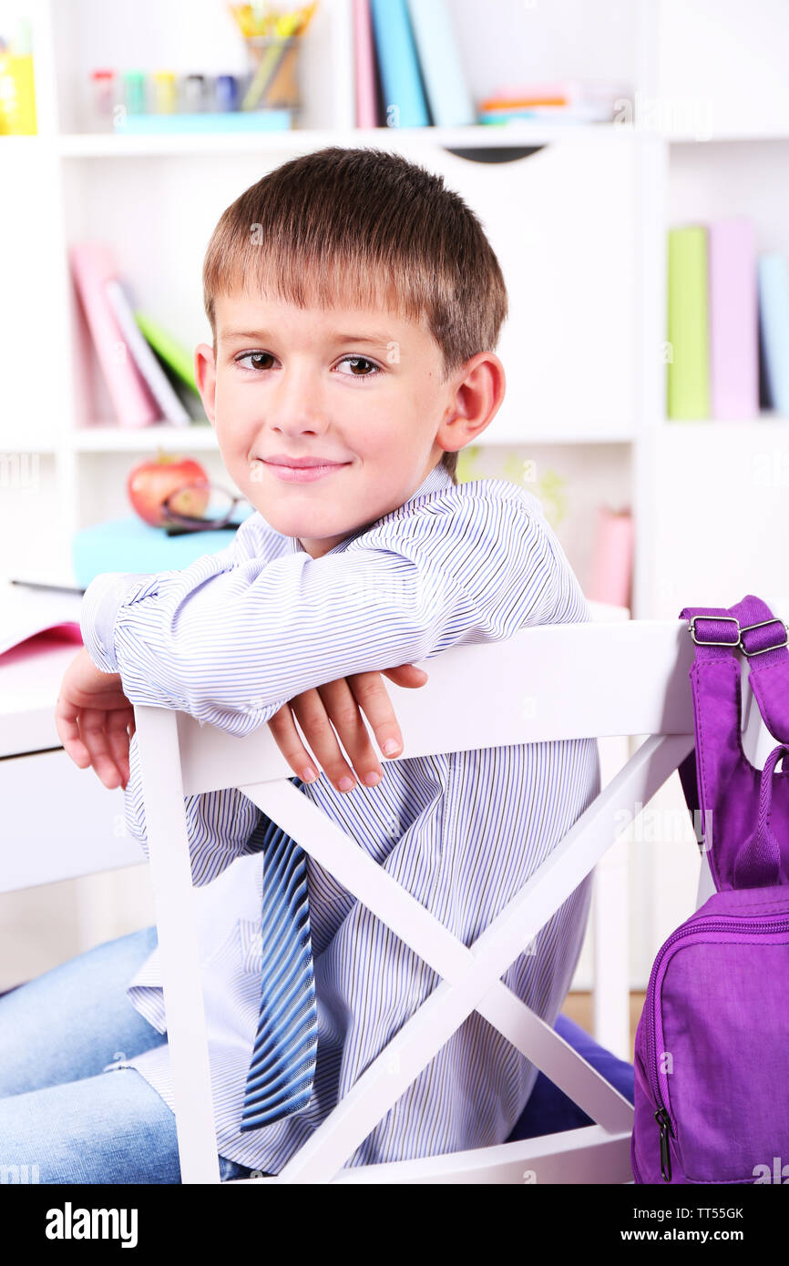 Schoolboy sitting at table in classroom Stock Photo - Alamy