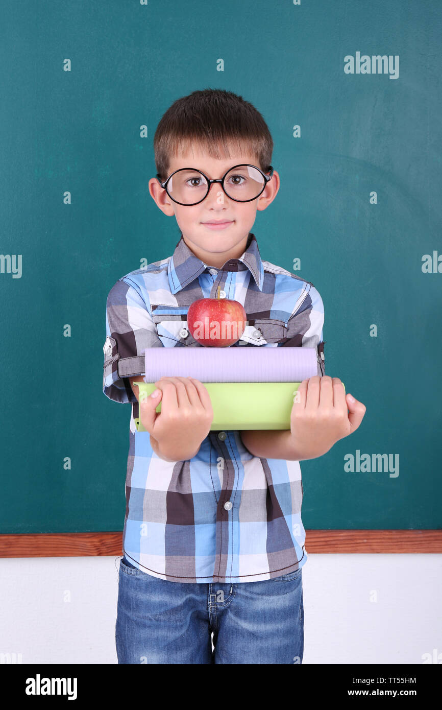 Schoolboy at blackboard in classroom Stock Photo - Alamy