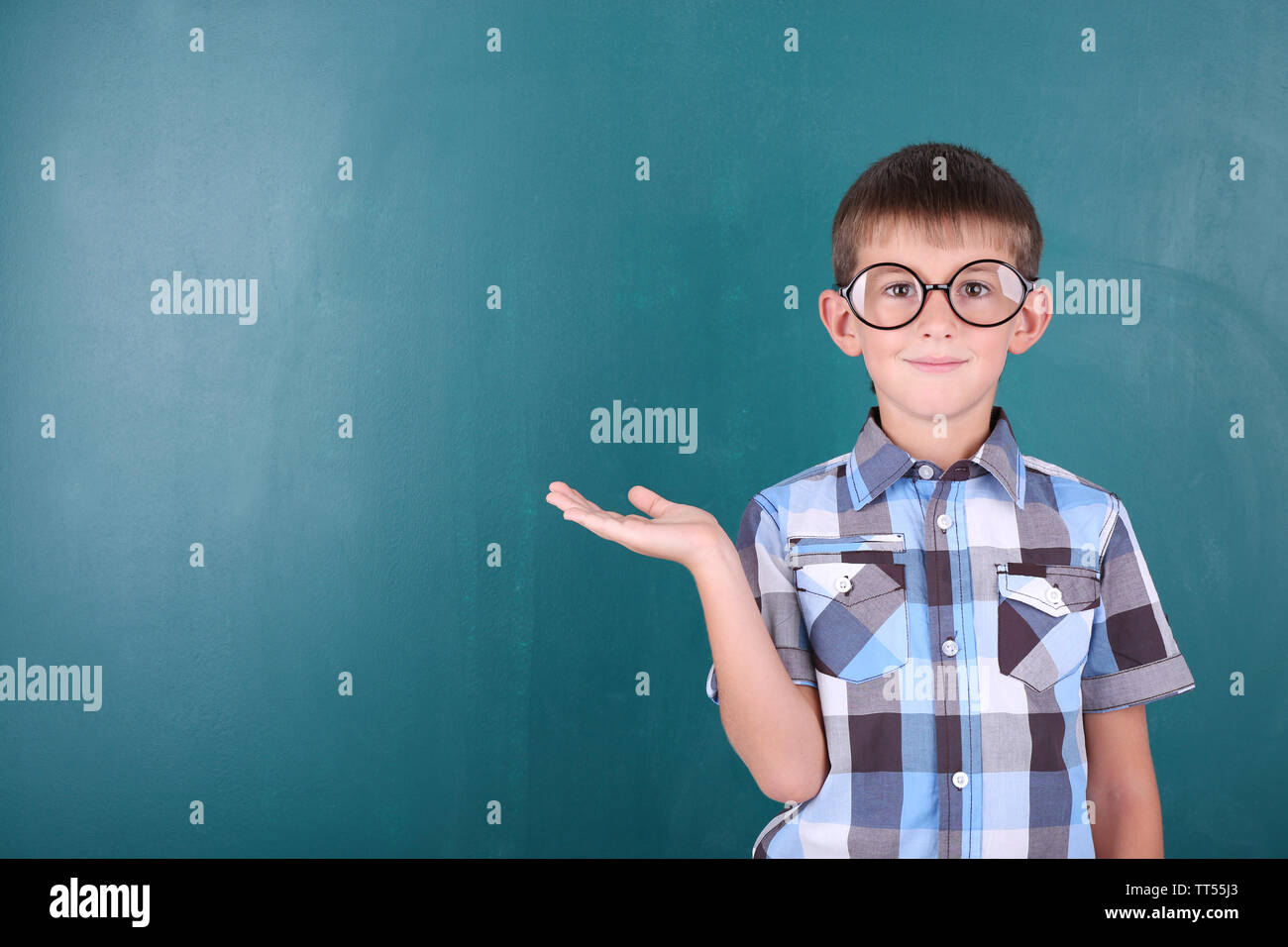Schoolboy at blackboard in classroom Stock Photo - Alamy