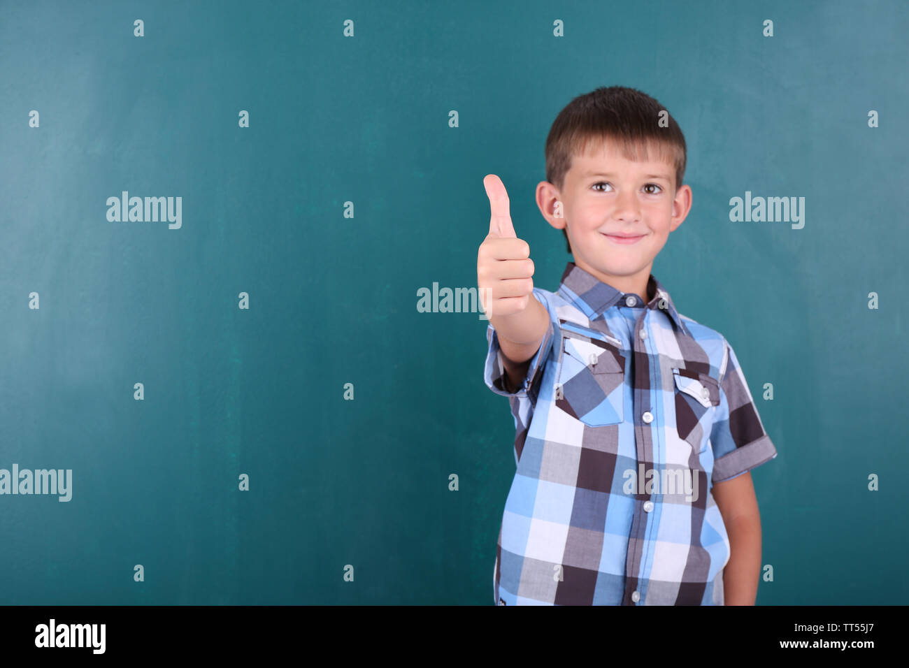 Schoolboy at blackboard in classroom Stock Photo - Alamy
