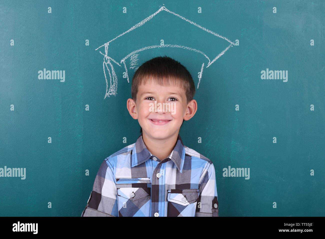 Schoolboy at blackboard in classroom Stock Photo - Alamy