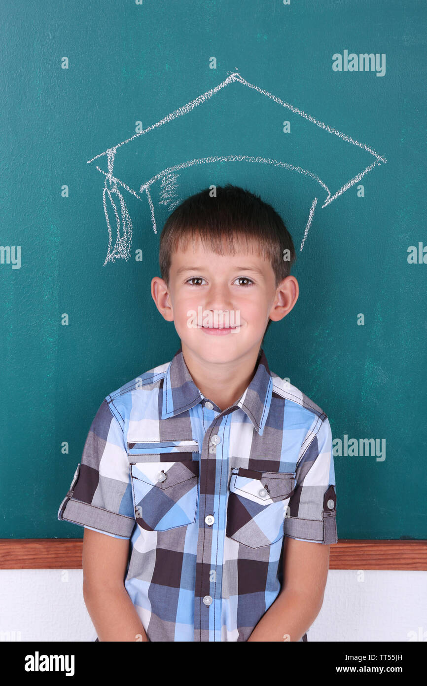 Schoolboy at blackboard in classroom Stock Photo - Alamy