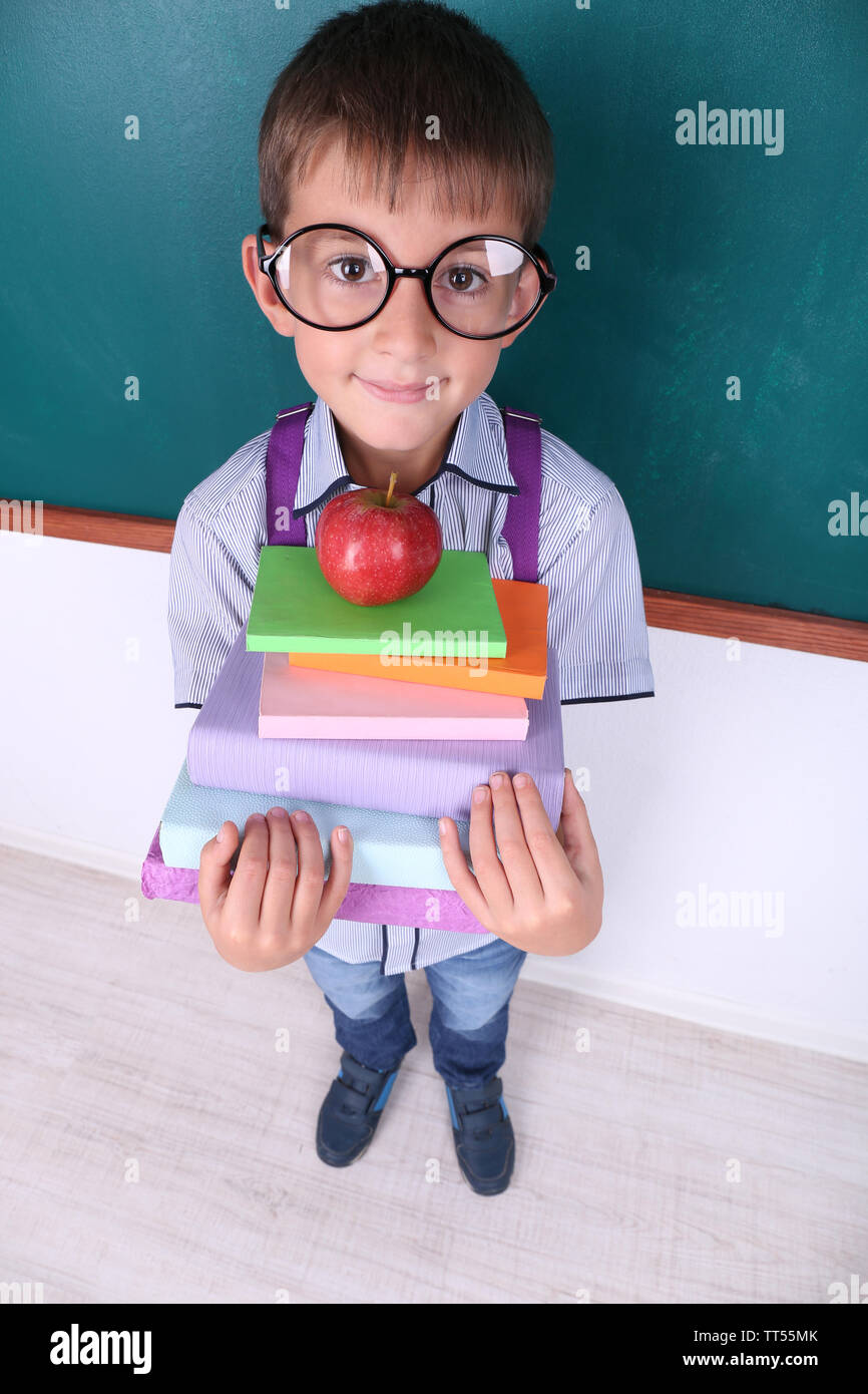 Schoolboy at blackboard in classroom Stock Photo - Alamy