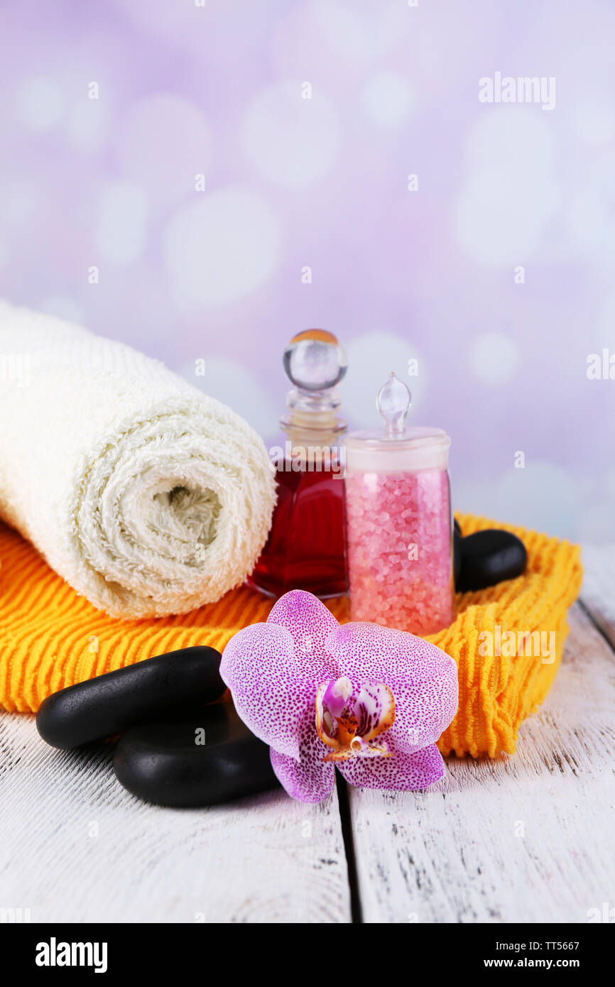 Still life with beautiful blooming orchid flower, spa set on color ...