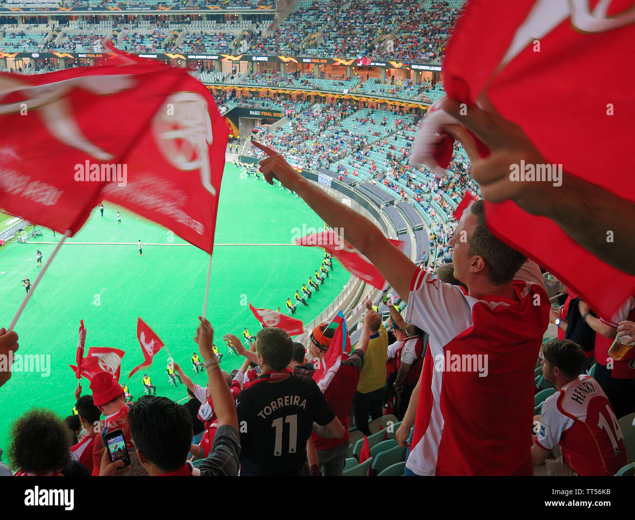 Arsenal fans singing and waving flags in anticipation of the UEFA ...