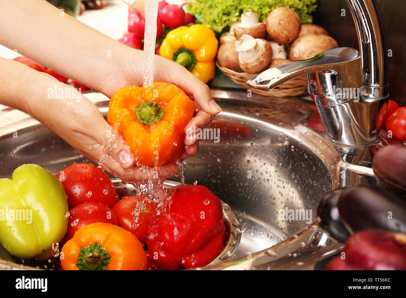 Woman's hands washing vegetables in sink in kitchen Stock Photo - Alamy