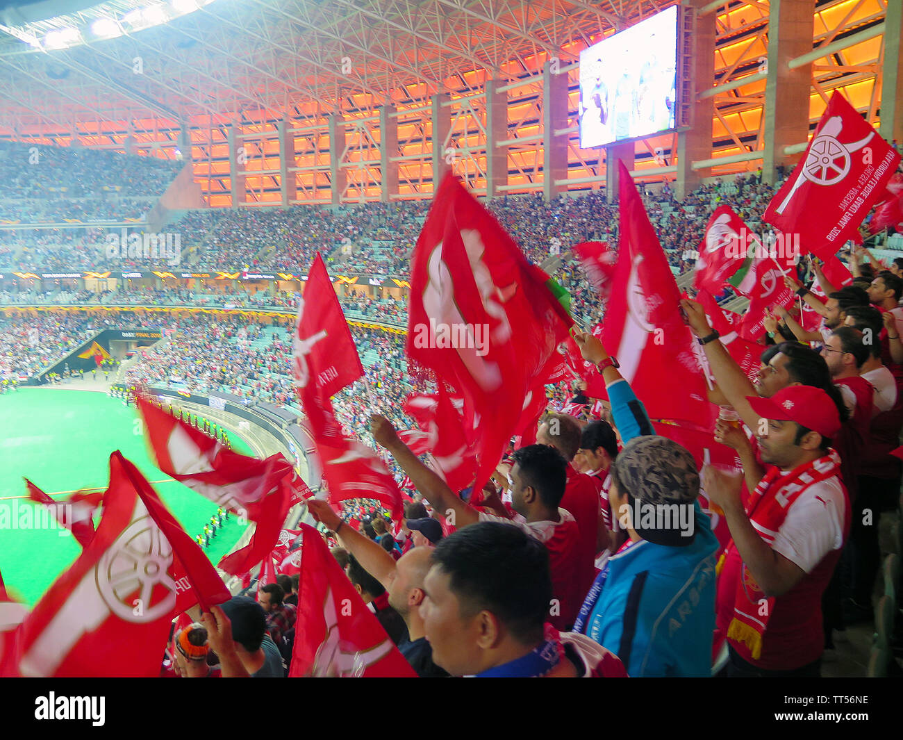 Arsenal fans singing and waving flags in anticipation of the UEFA ...