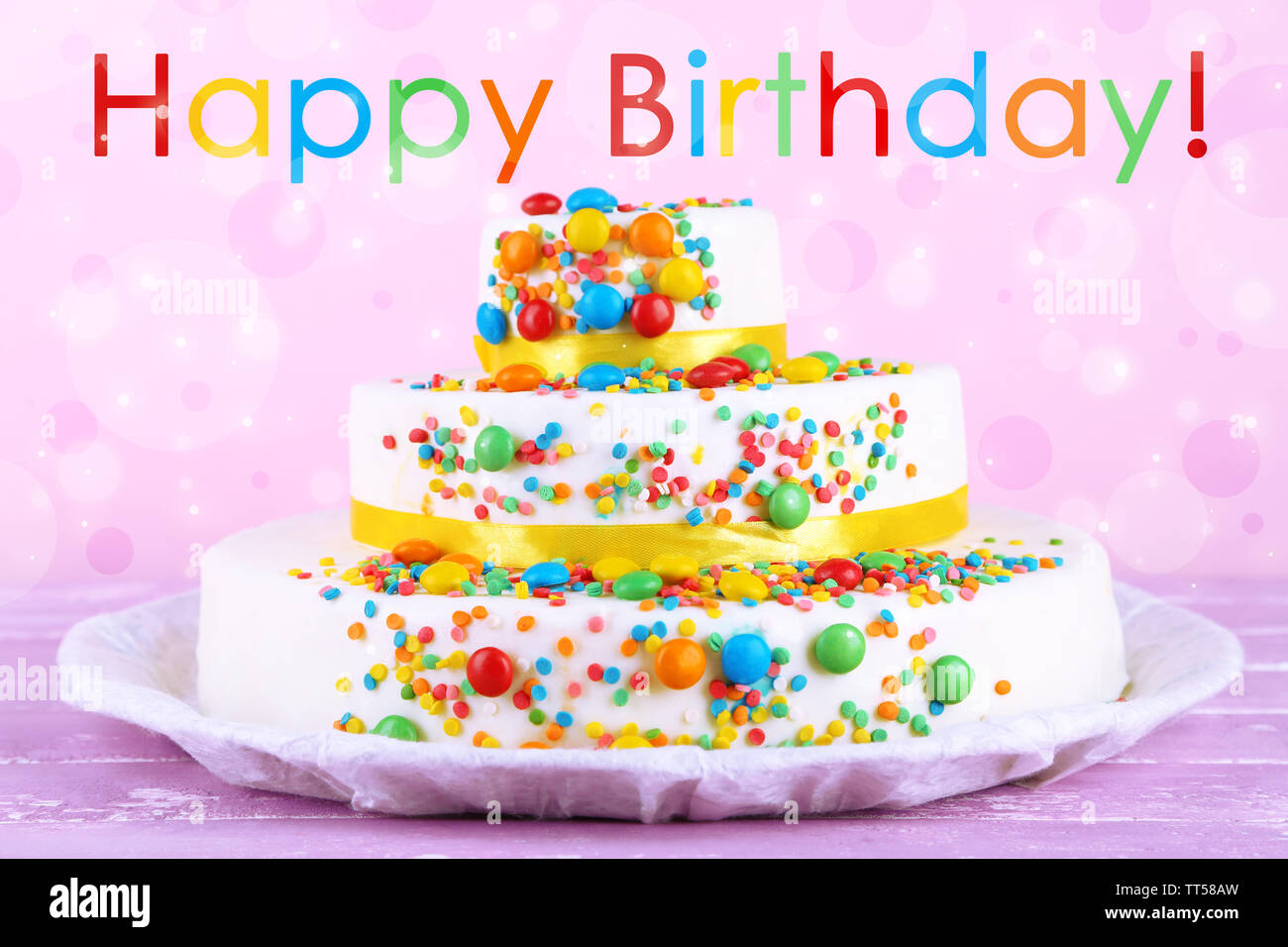 Beautiful tasty cake and phrase HAPPY BIRTHDAY on color background ...