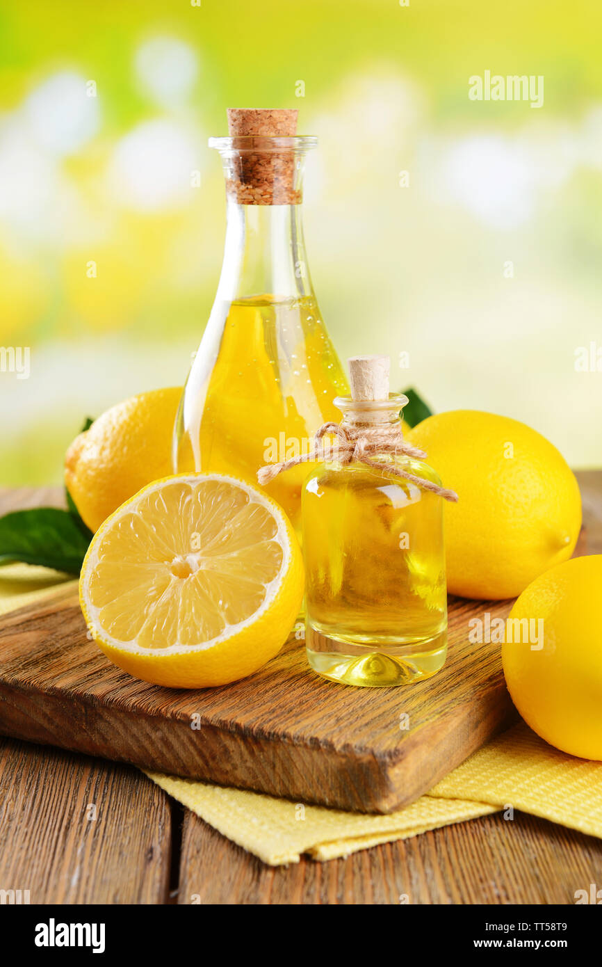 Lemon oil on table on light background Stock Photo - Alamy