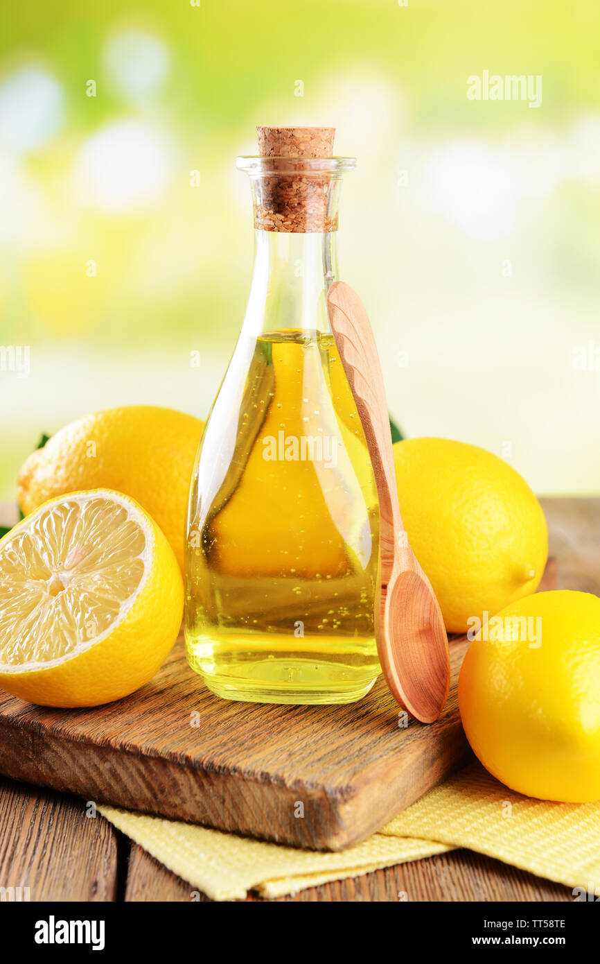 Lemon oil on table on light background Stock Photo - Alamy