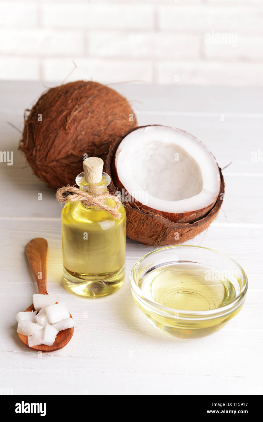 Coconut oil on table on light background Stock Photo - Alamy